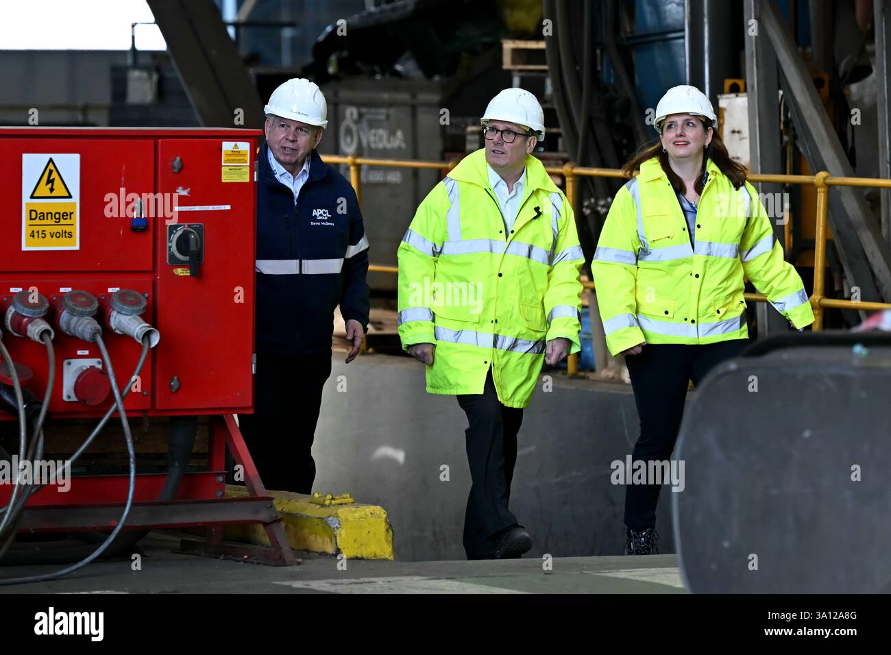 Prime Minister Sir Keir Starmer (centre) walks through a construction ...