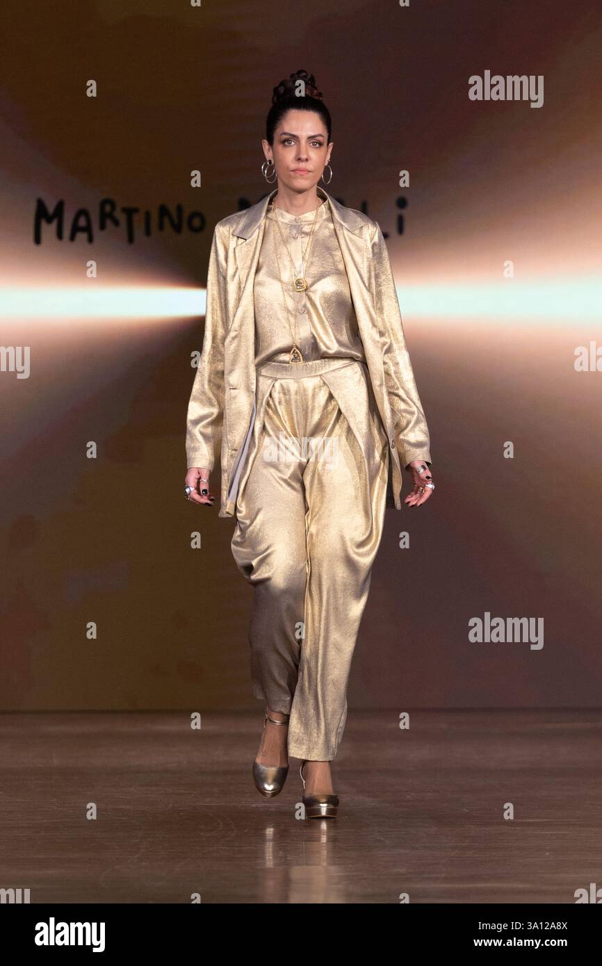 Milan, Italy. 24 Feb, 2025. A model walks the runway during the Martino ...