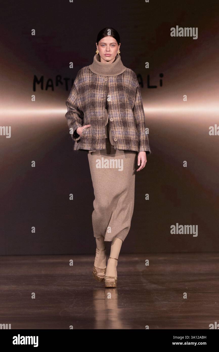 Milan, Italy. 24 Feb, 2025. A model walks the runway during the Martino ...