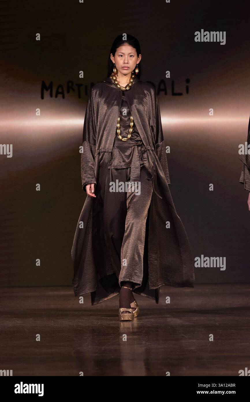 Milan, Italy. 24 Feb, 2025. A model walks the runway during the Martino ...