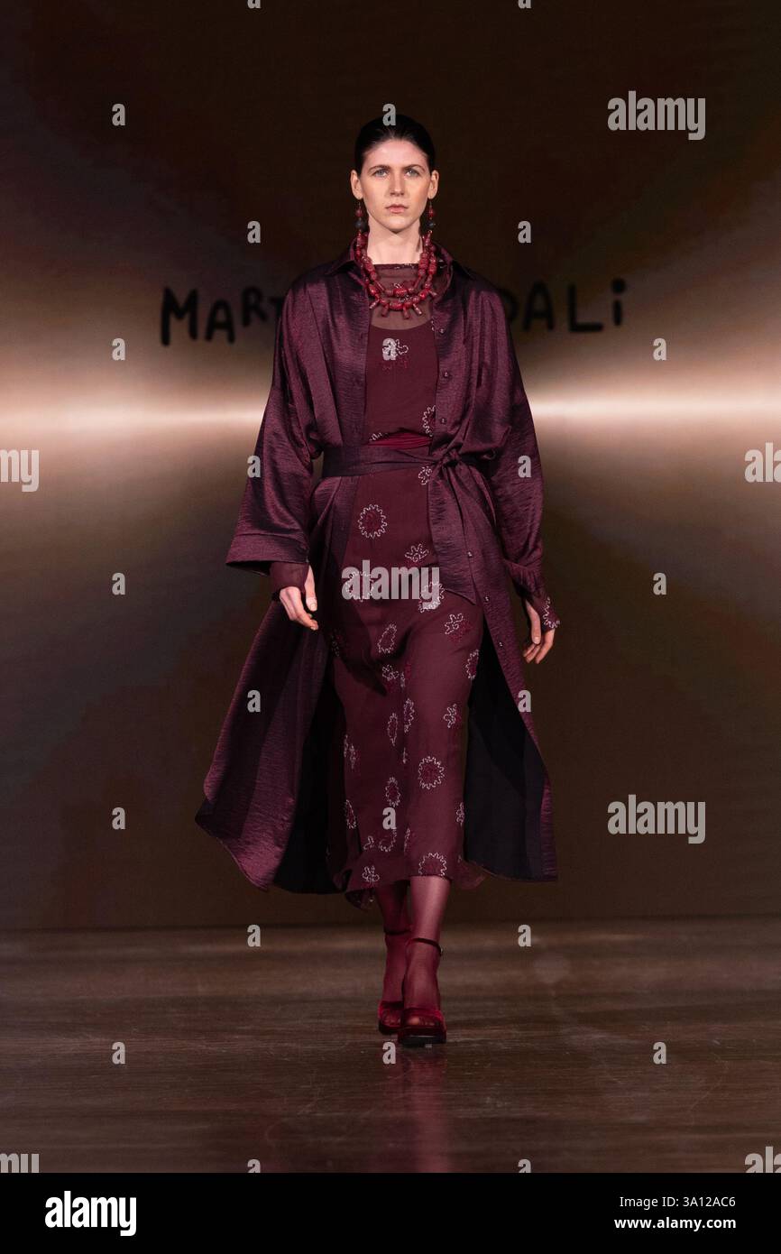 Milan, Italy. 24 Feb, 2025. A model walks the runway during the Martino ...
