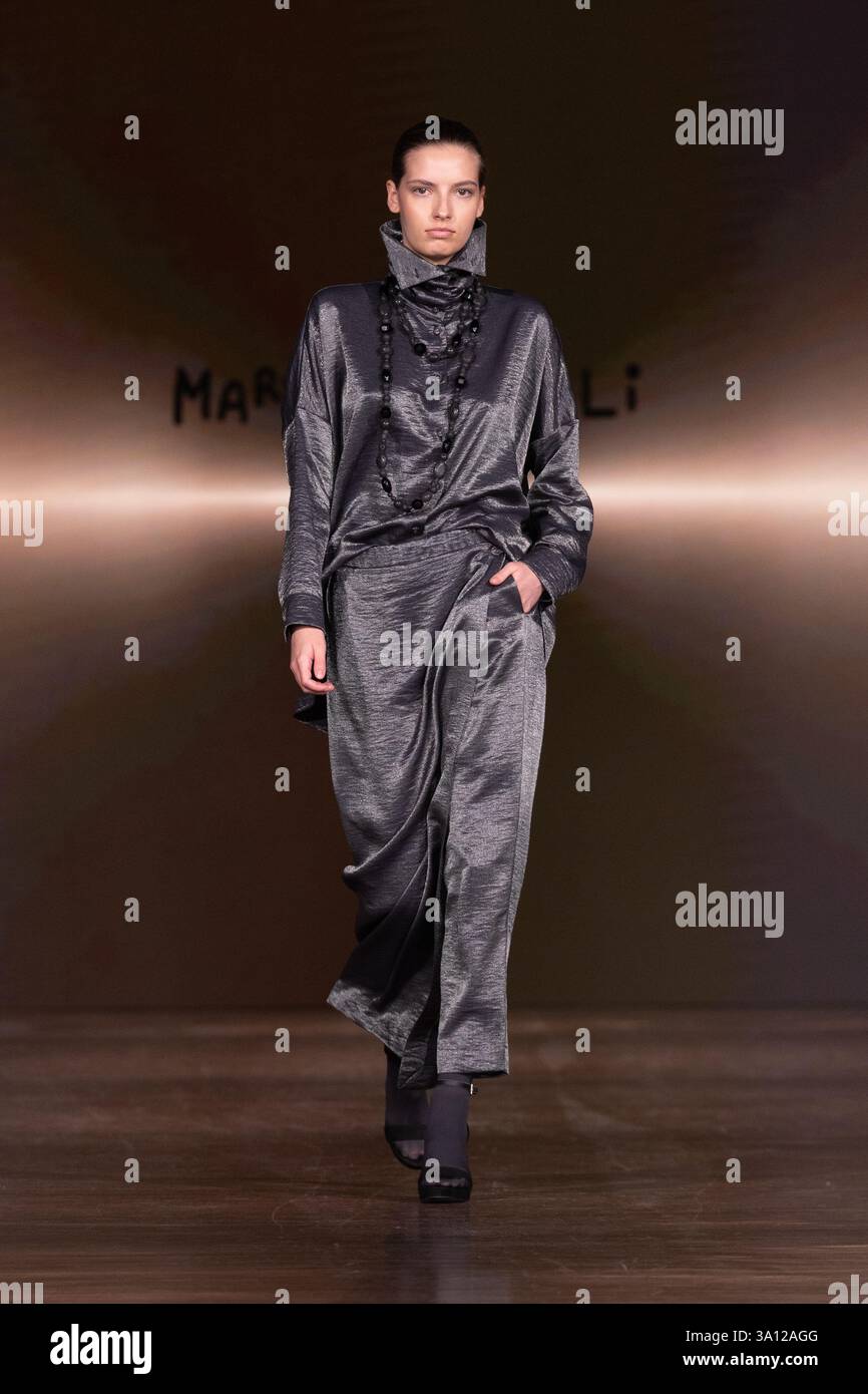 Milan, Italy. 24 Feb, 2025. A model walks the runway during the Martino ...