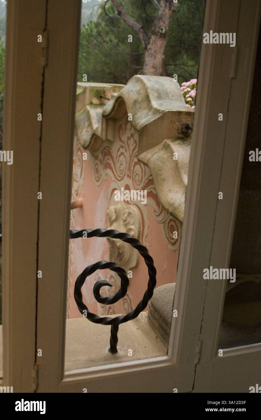 Intricate patterns and relief sculpture on an outdoor wall, framed by a ...