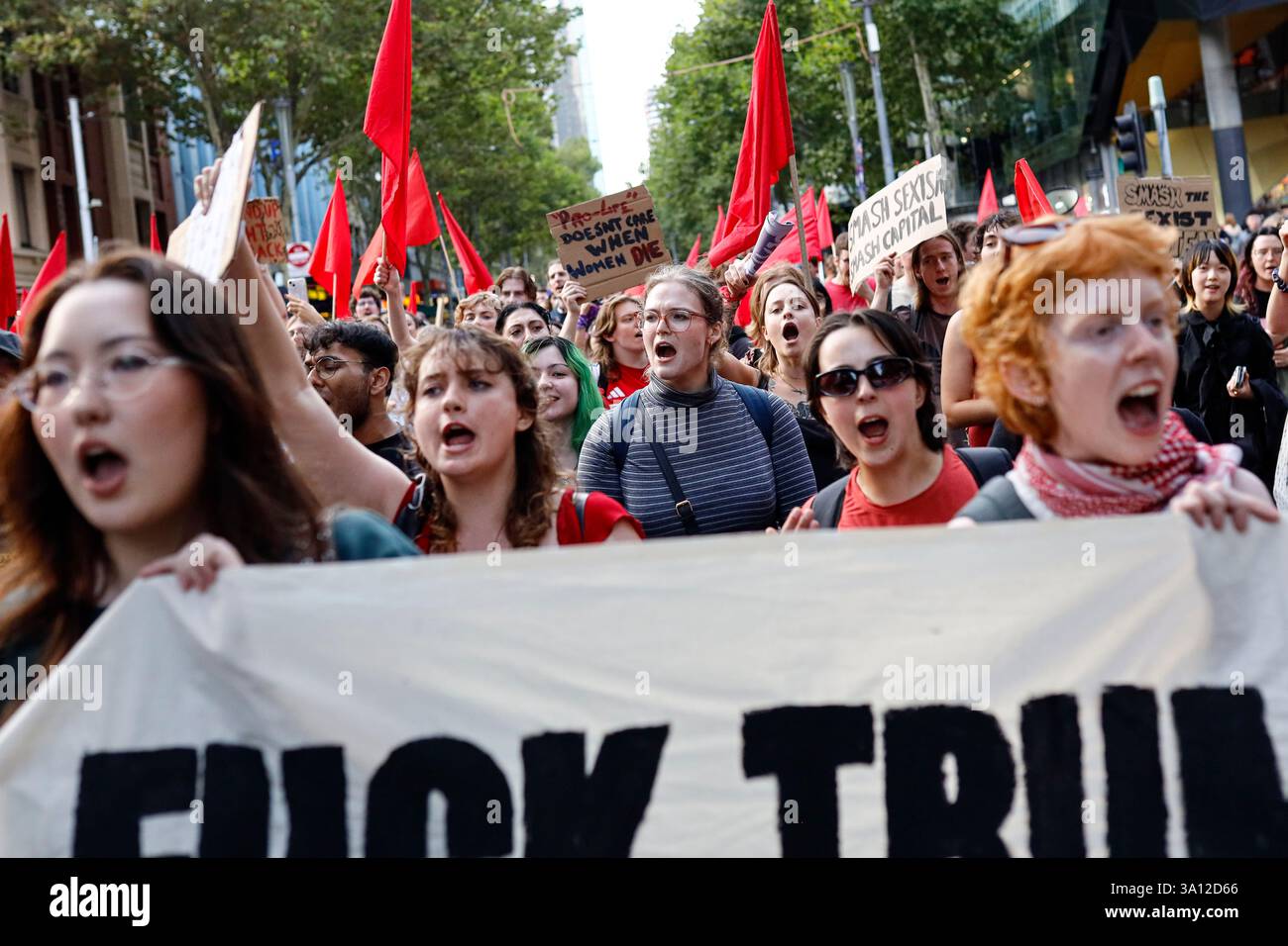 Protesters march with banners and signs while chanting slogans during ...
