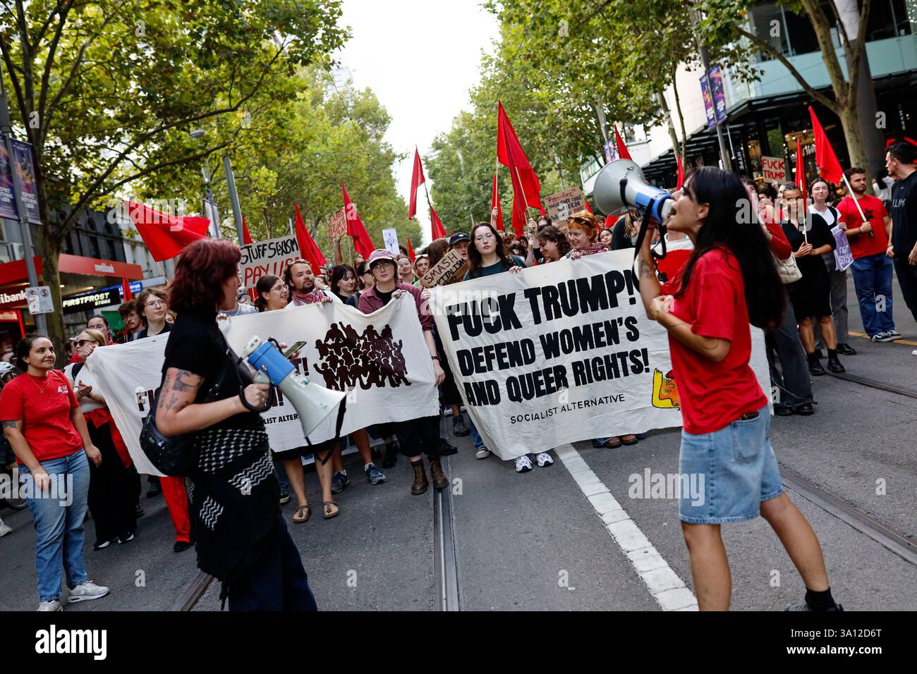 Protesters march with banners and signs while chanting slogans during ...