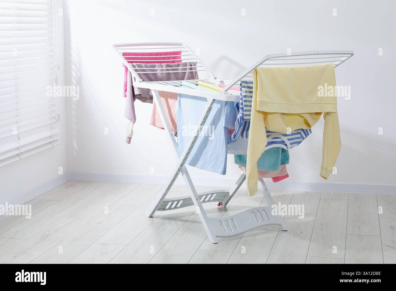 Drying rack with fresh clean laundry at home Stock Photo - Alamy