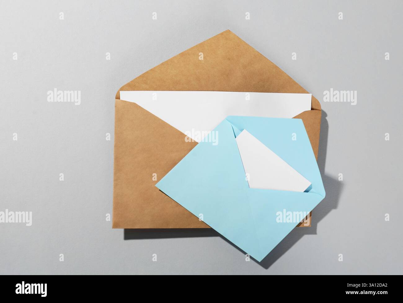Paper envelopes with letters on grey background, above view. Mockup for ...