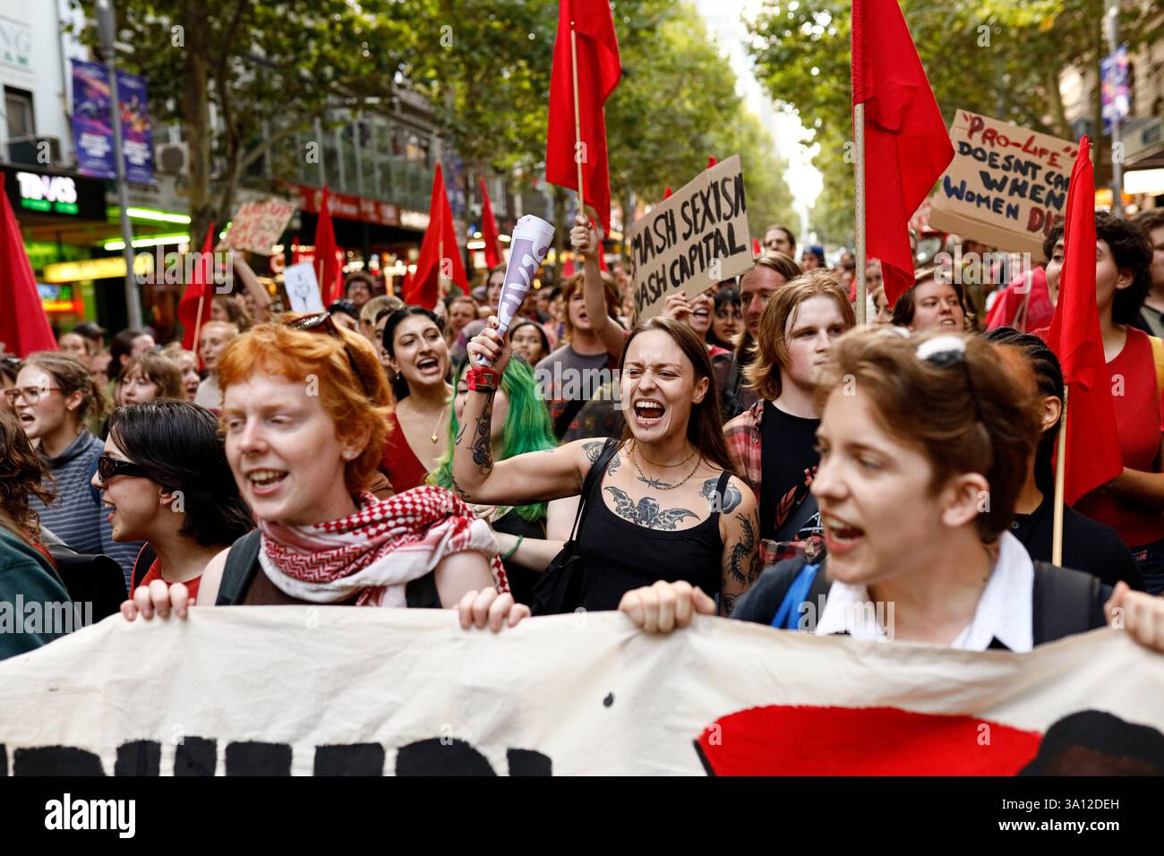 Protesters shout slogans and hold banners during the International ...