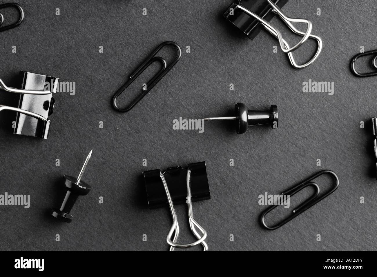Paper clips and pins on black background, flat lay Stock Photo - Alamy