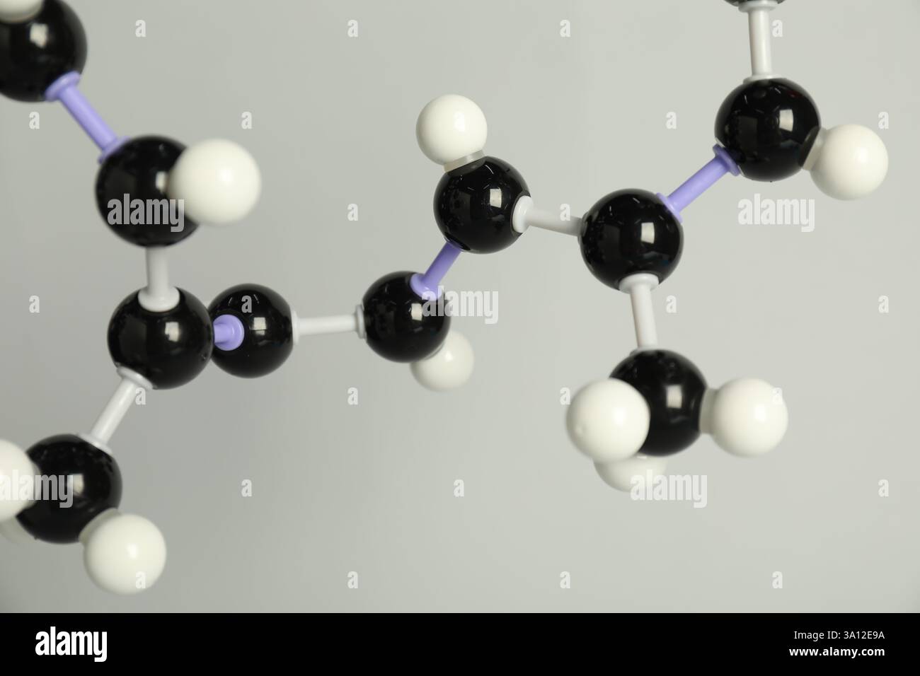 Molecule of retinol (vitamin A) on light grey background, closeup ...