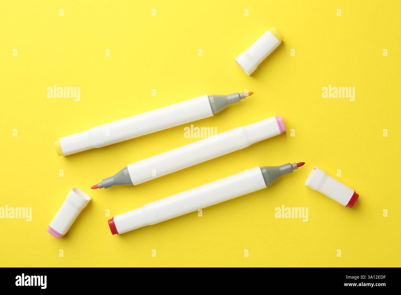 Colorful double sided markers on yellow background, flat lay Stock ...