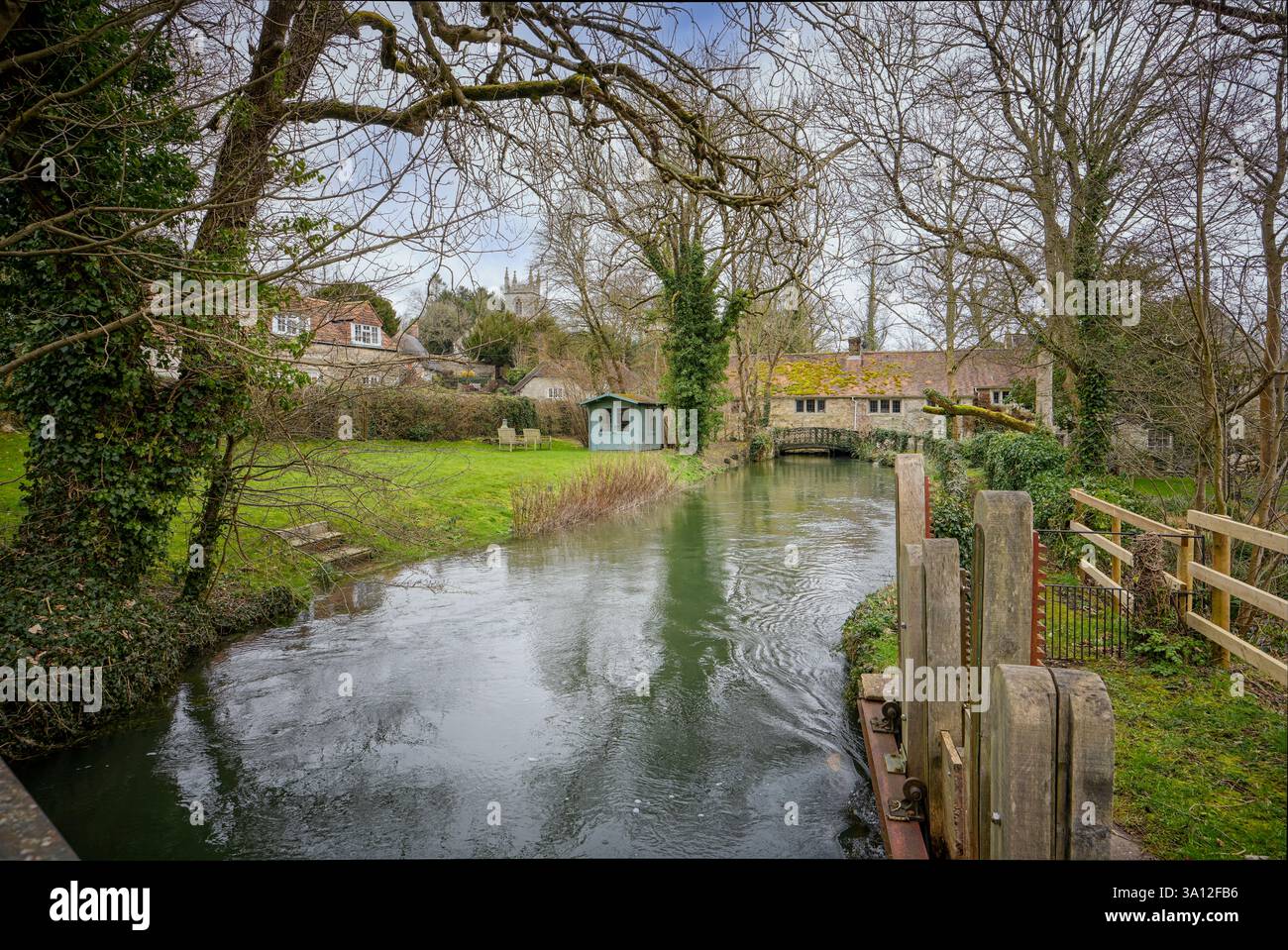 The River Wylye flowing past sluice gate in Fisherton de la Mere in ...