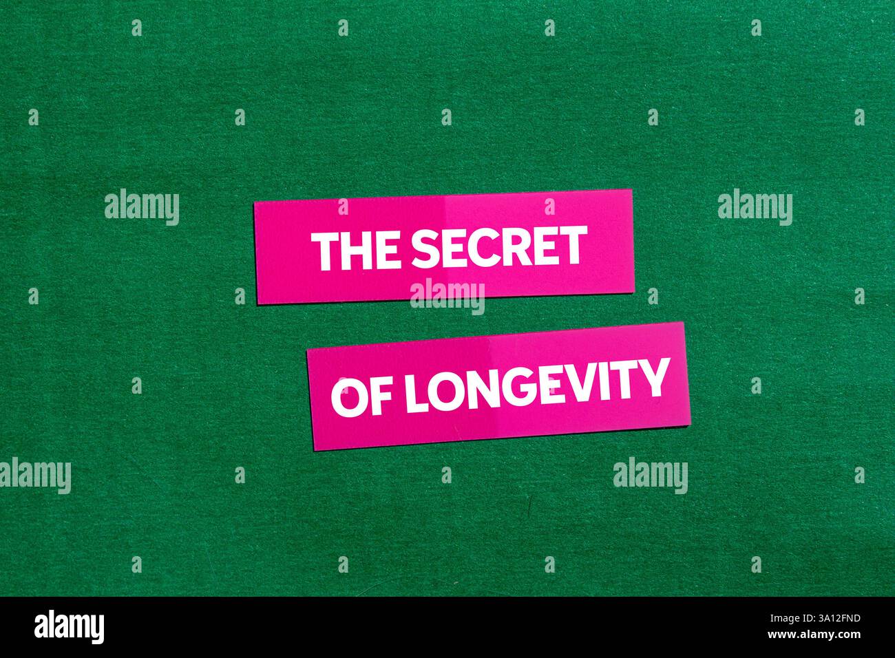 The secret of longevity message written on pink stickers on green ...