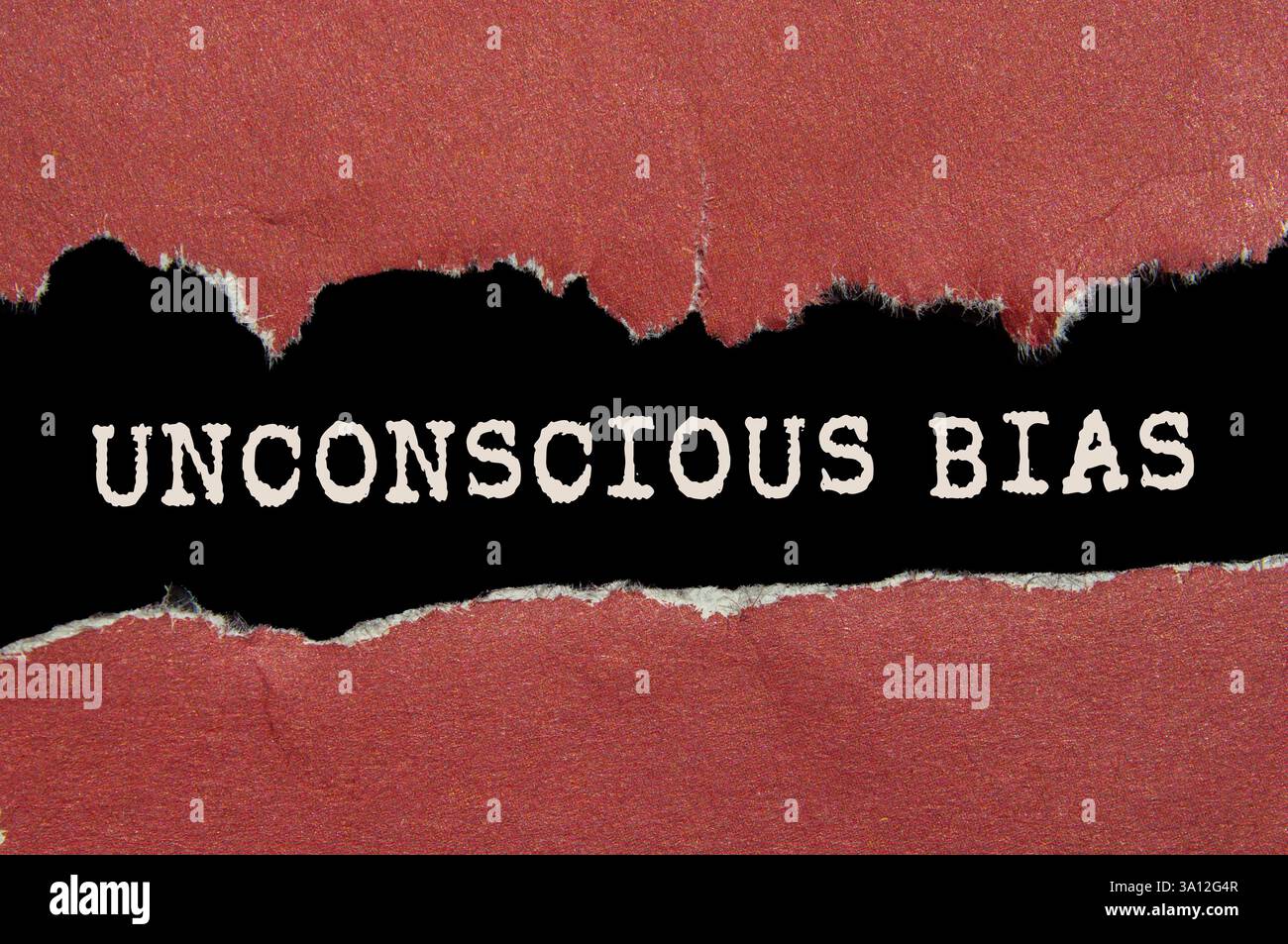 Unconscious bias message written on ripped torn red paper on black background. Conceptual ...