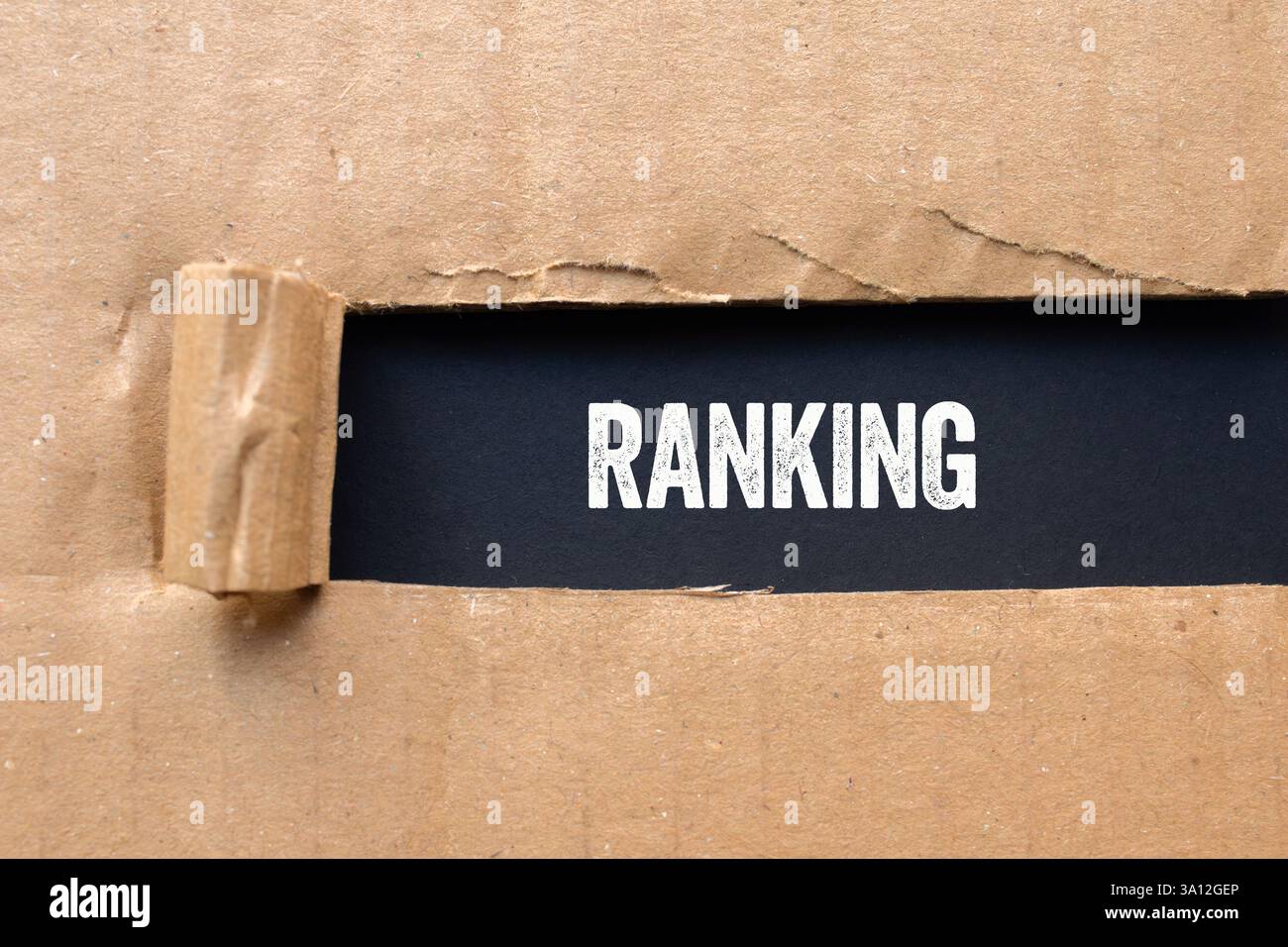 Ranking message written on ripped torn cardboard paper on black background. Conceptual ranking ...