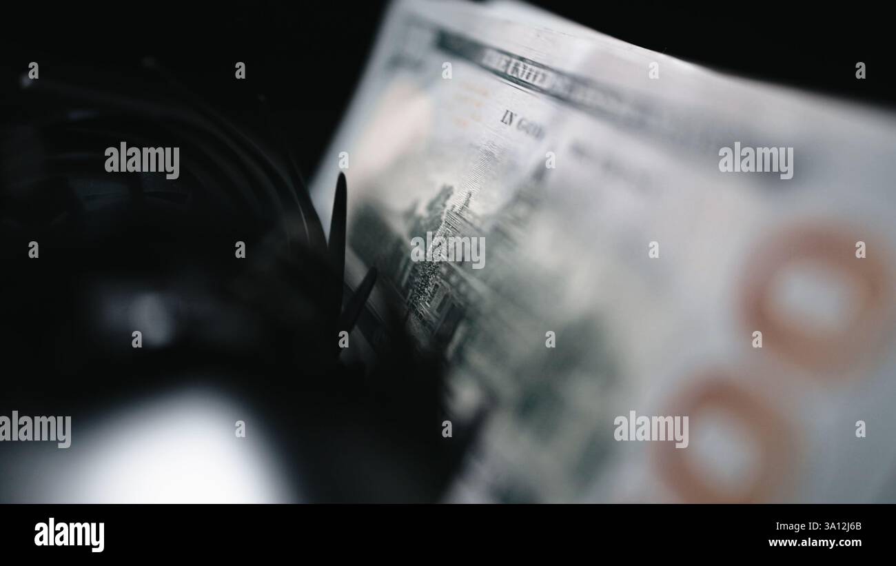 Automatic money counting machine sorts 100 dollar bills with an image ...