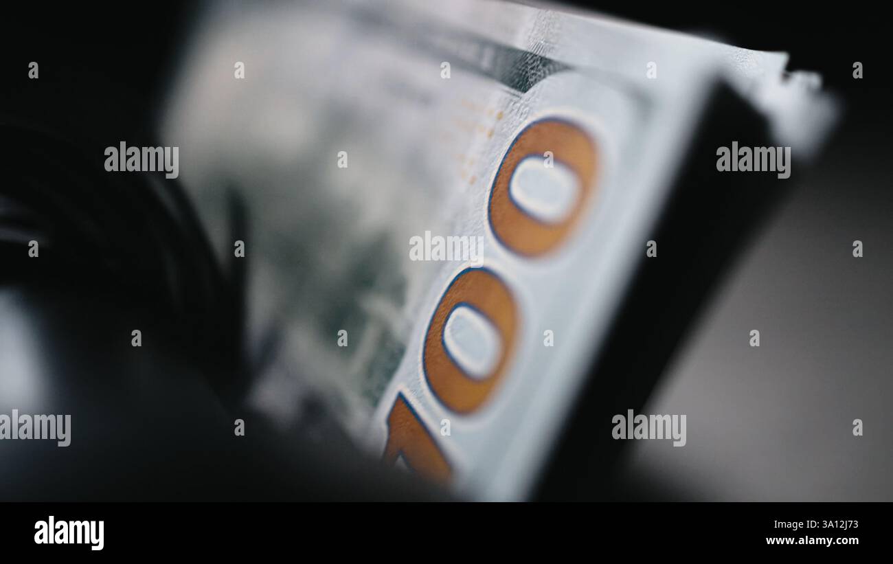 Automatic money counting machine sorts 100 dollar bills with an image ...