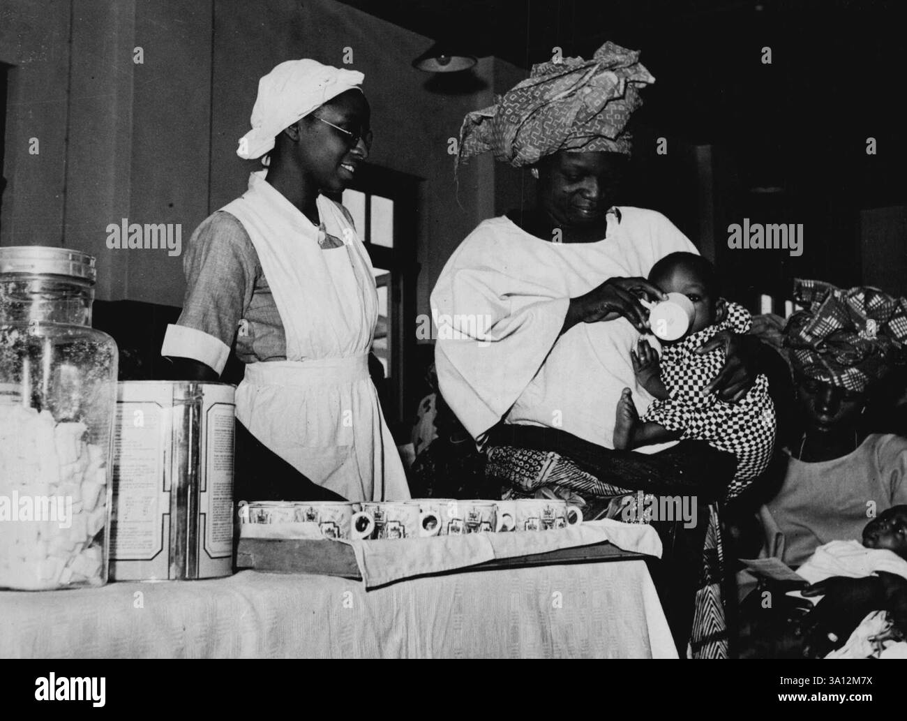 Infant Welfare in Lagos, Nigeria. Baby sampling soup at the clinic ...