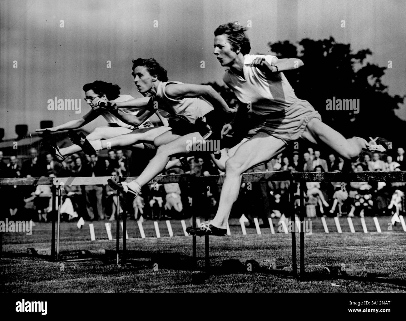 Dutch champion Mrs. Fanny Blankers-Koen (nearer camera) gains a slight ...
