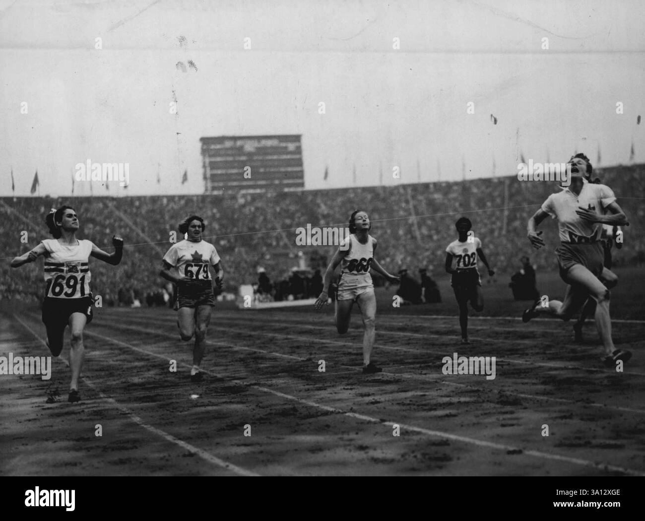 Photo shows : The finish of the 100 metres women's Final at Wembley ...