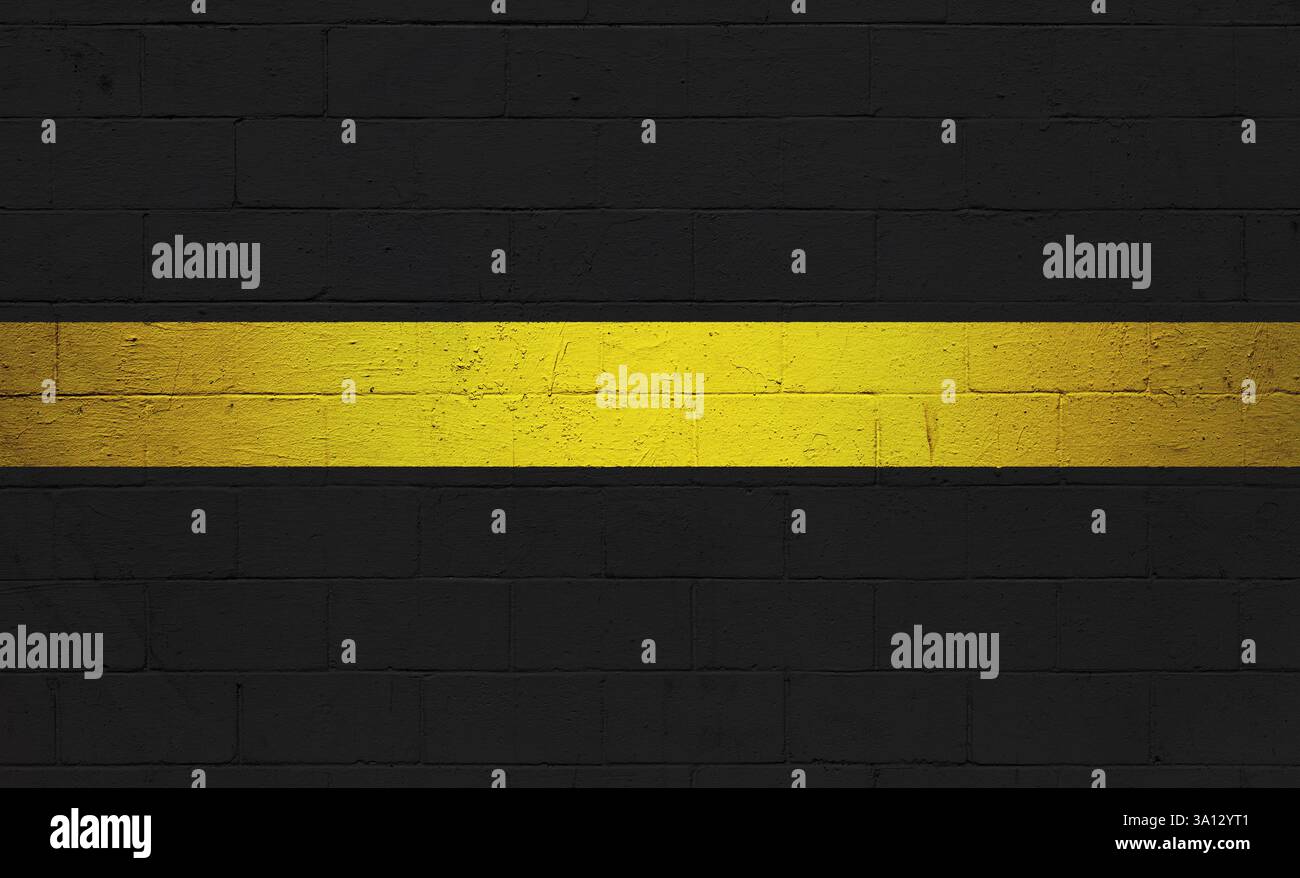 American Dispatcher Thin Gold Line painted on a cinder block wall Stock ...