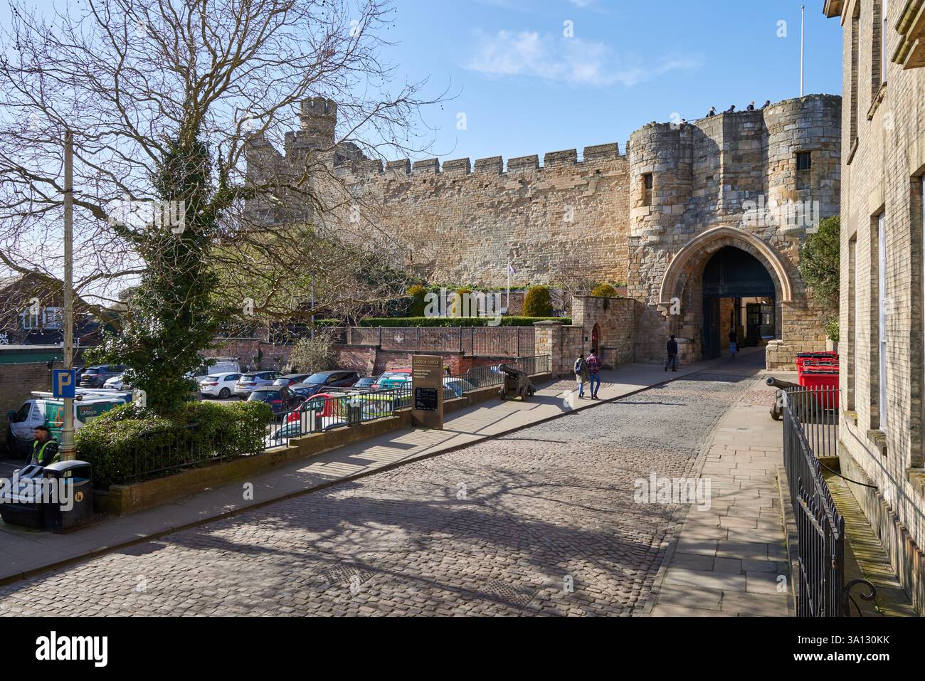 The front gate of Lincoln Castle features a grand medieval stone ...