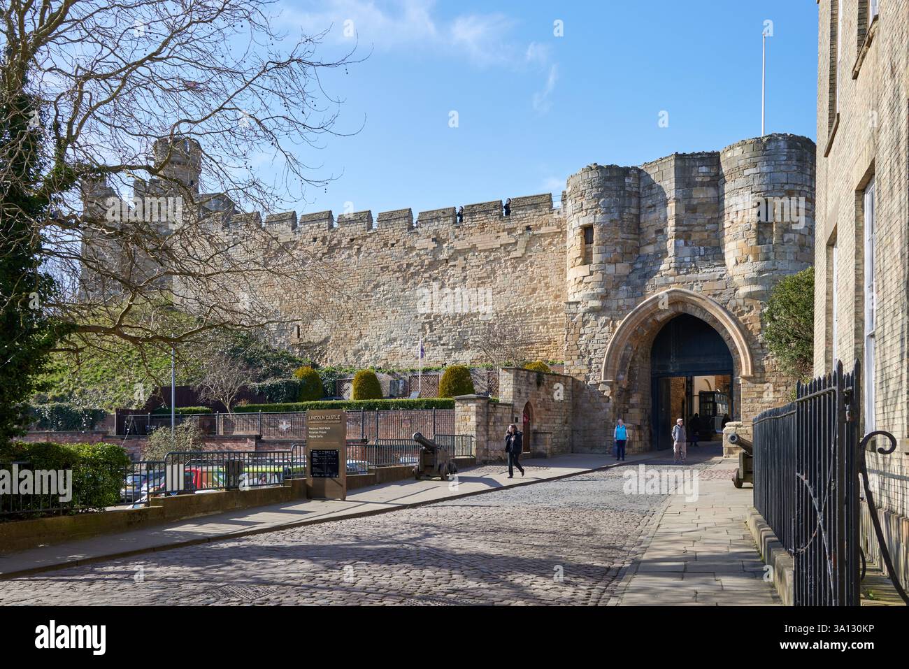 The front gate of Lincoln Castle features a grand medieval stone ...