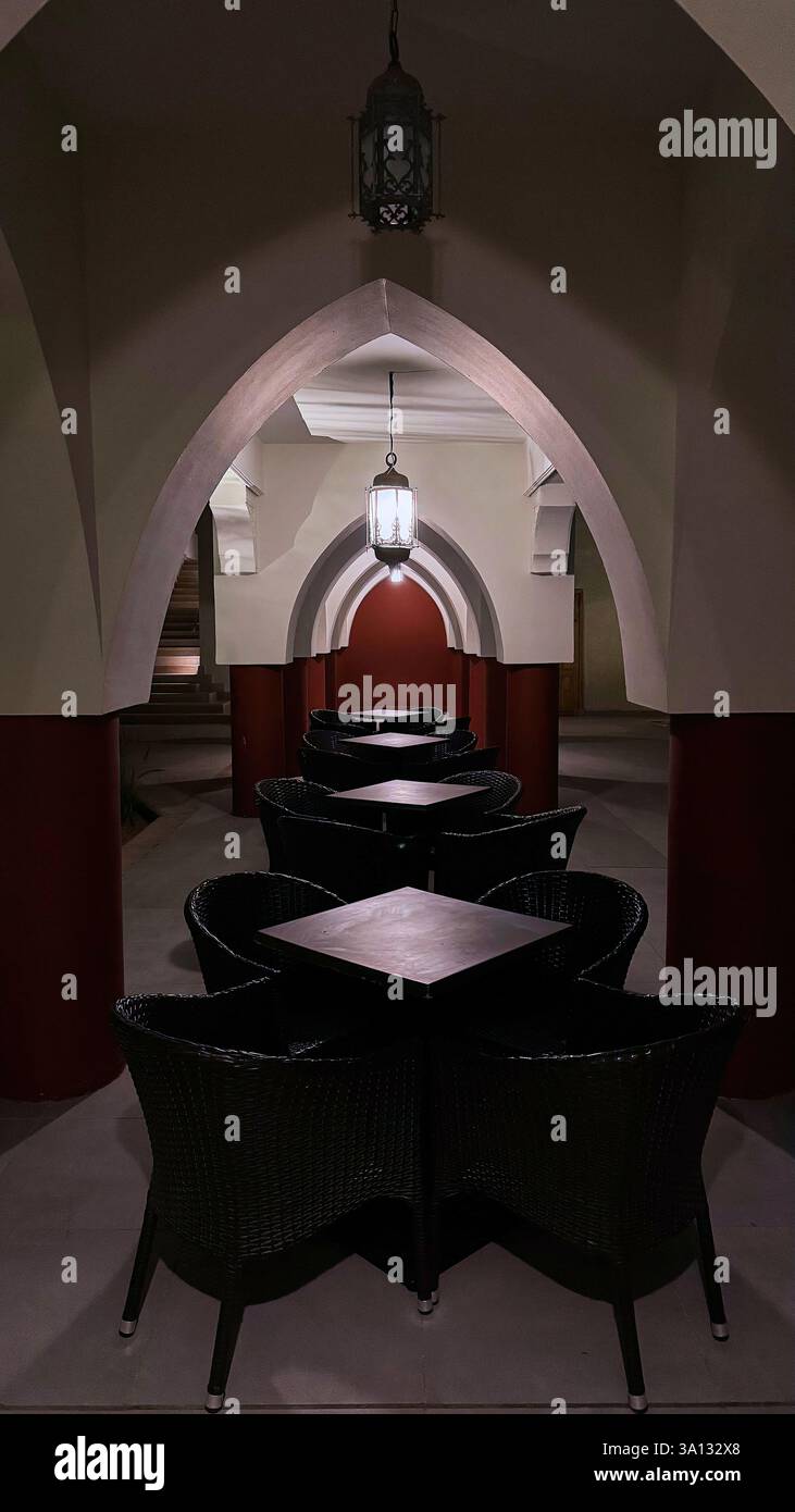Atmospheric photo of a dimly lit outdoor seating area Stock Photo - Alamy