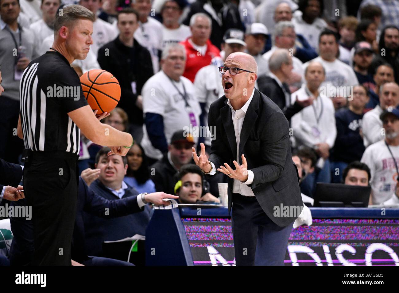 UConn head coach Dan Hurley, right, talks with referee Greg Evans ...