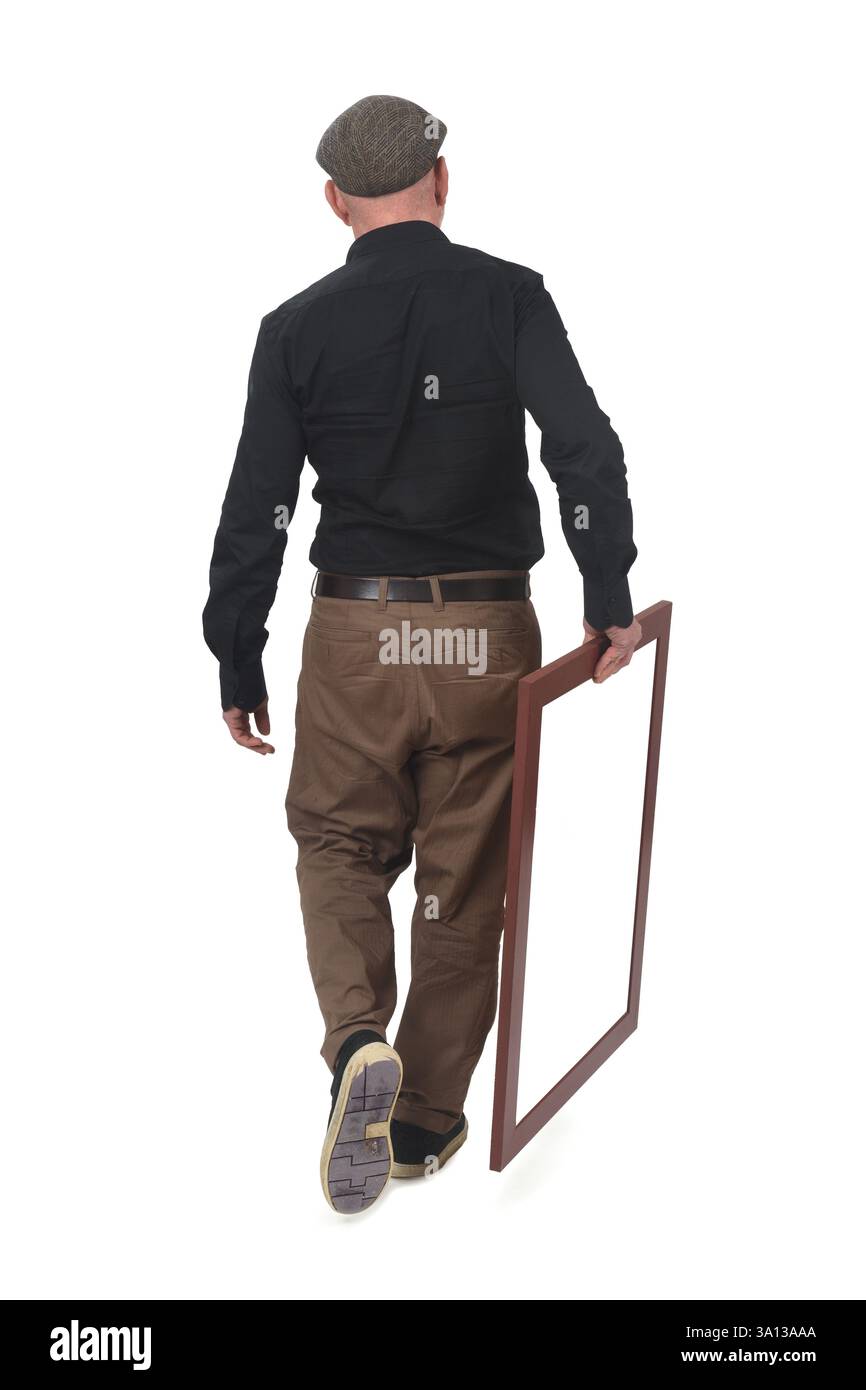 rear view of a man walking and carrying a blank frame on white ...