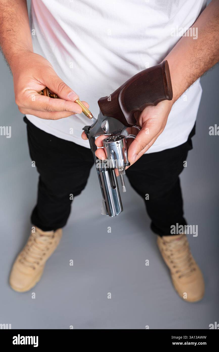Top down view of a shooting instructor wearing black pants and white ...