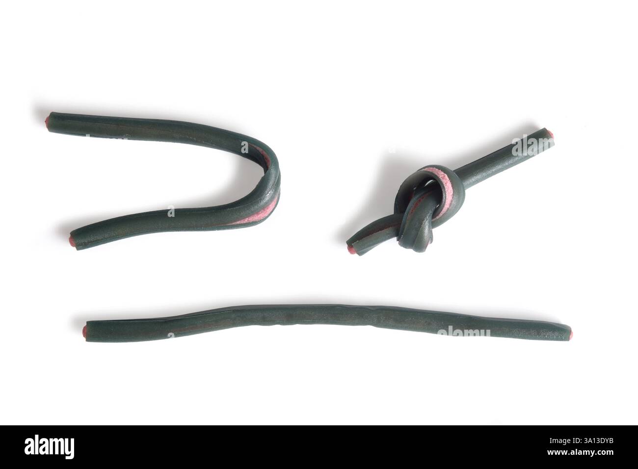 Raspberry and blackberry licorice sticks on white background Stock ...