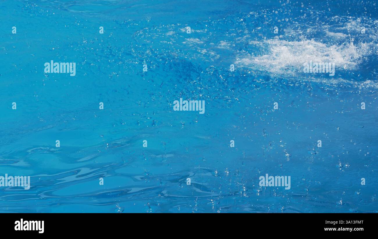 Rippling Blue Water Surface with Splash and Gentle Droplets Stock Photo ...