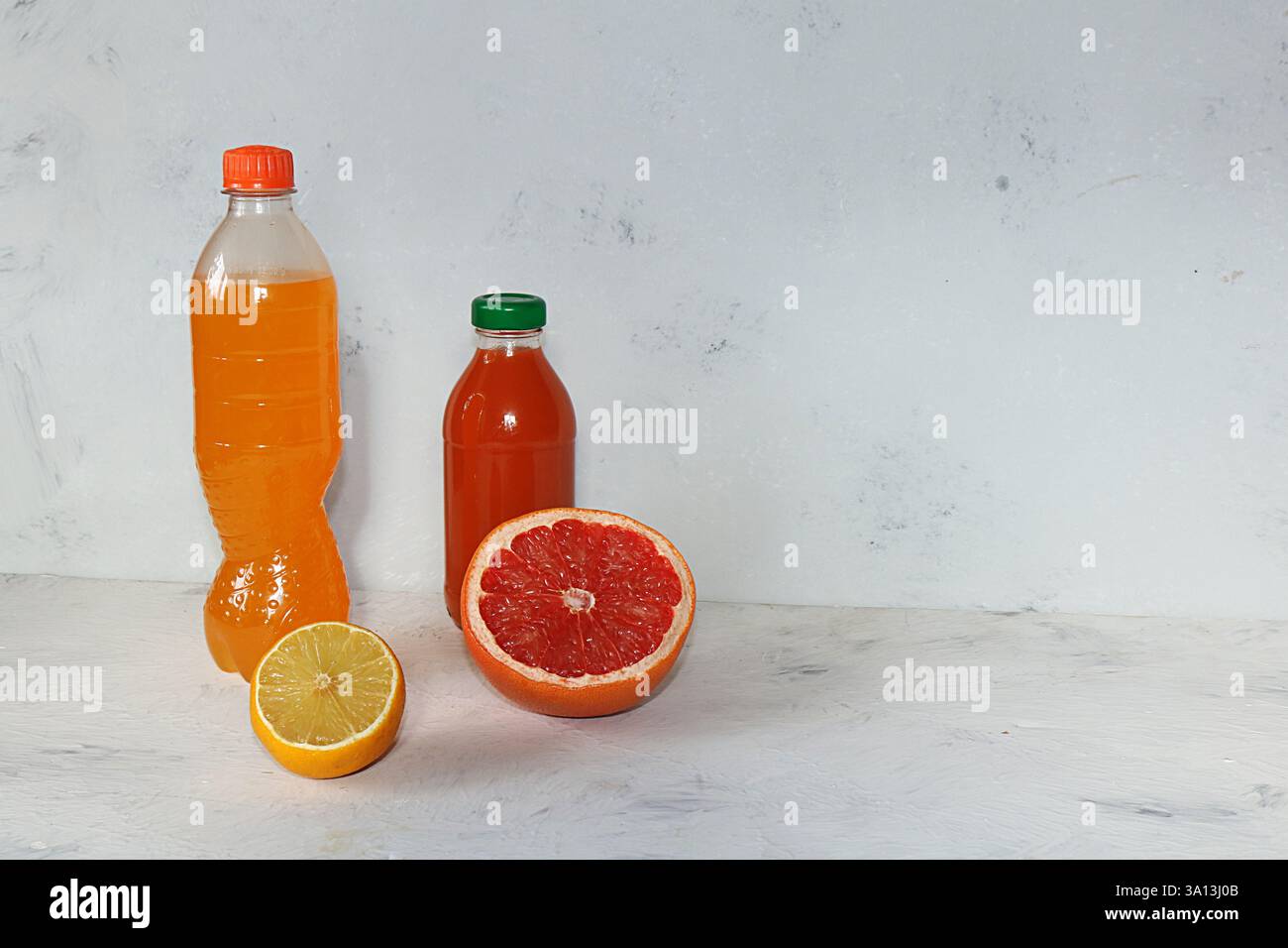 Homemade isotonic energy drink and ingredients. Red and yellow liquid ...