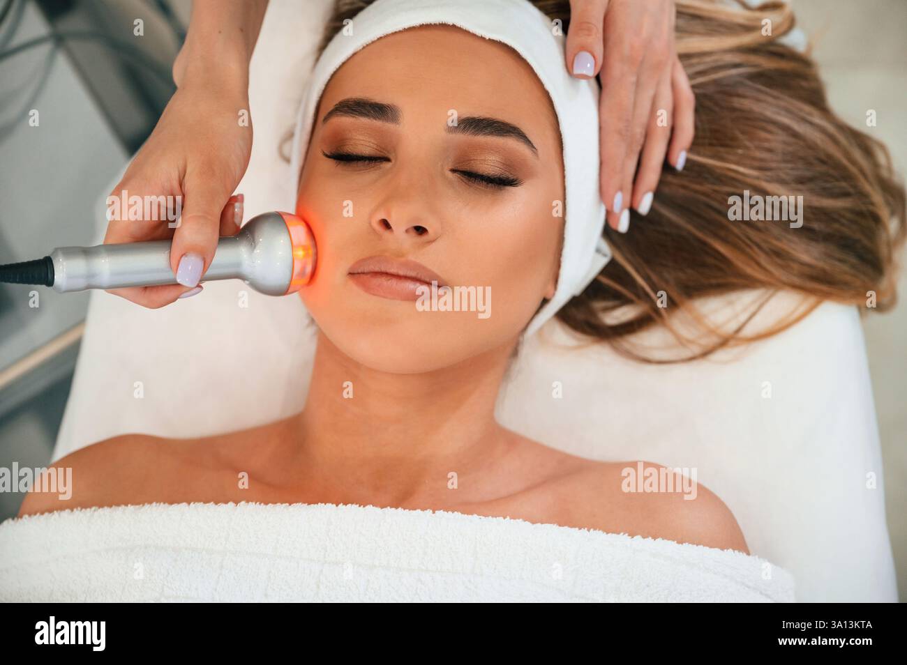 Apparatus for galvanization is used. Woman face getting facial care by ...