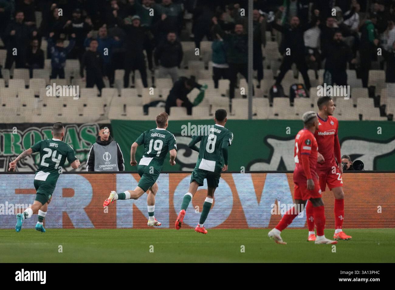 Panathinaikos' Karol Swiderski, second left, celebrates after scoring ...