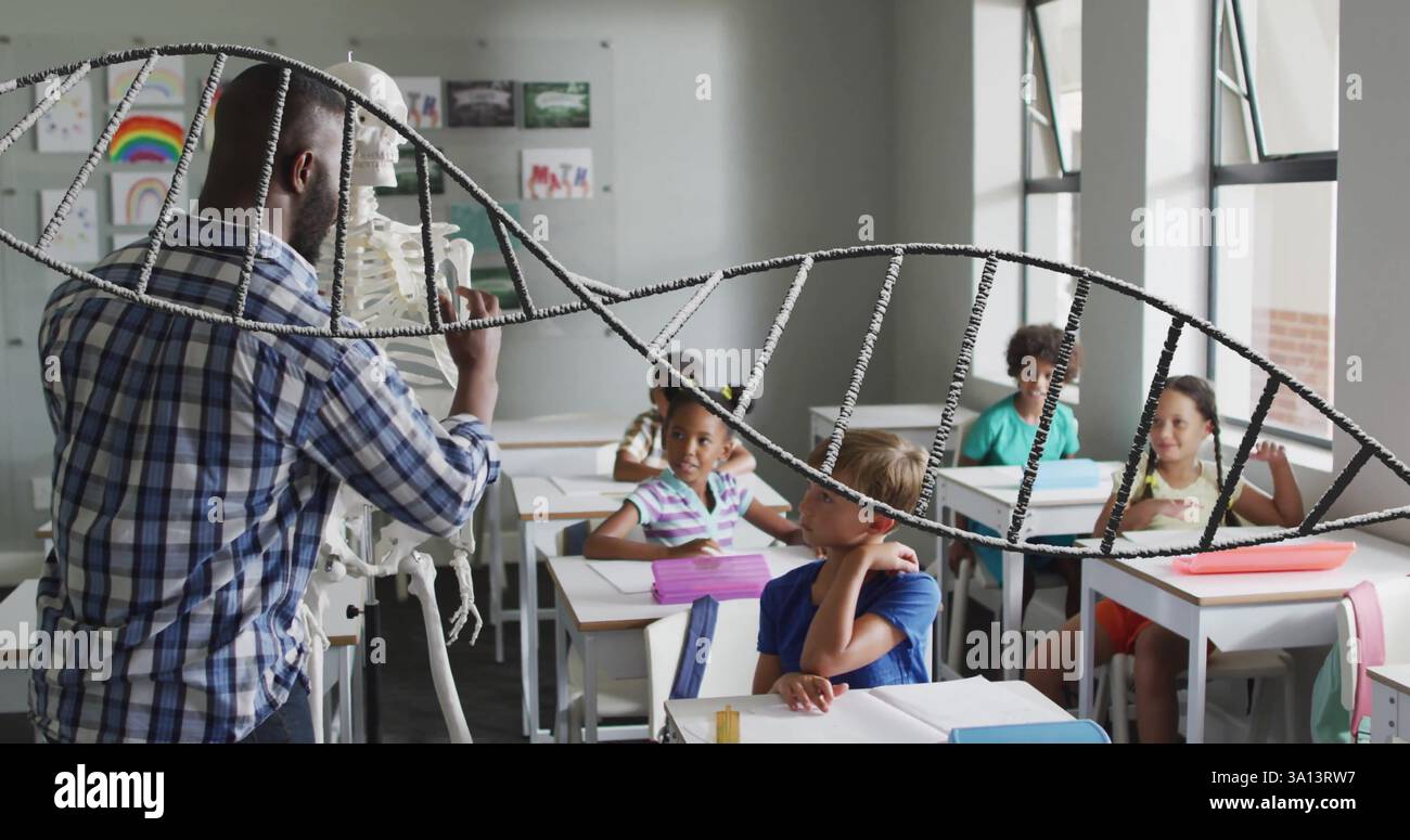 Image of dna strand over diverse male teacher and schoolchildren in ...