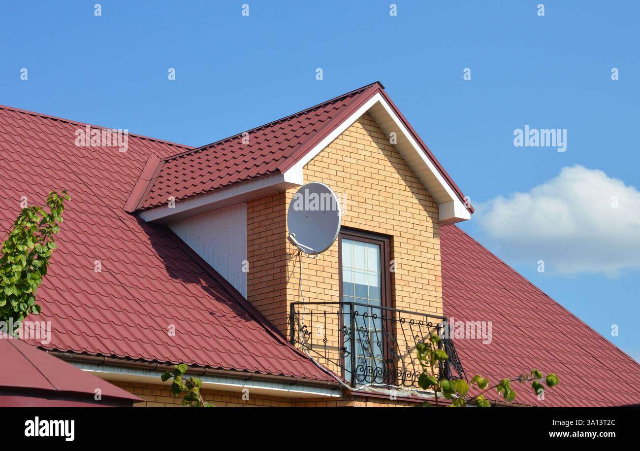 Metal roof with brick dormer, window, metal balcony, satellite dish, gutter, plastic soffits ...
