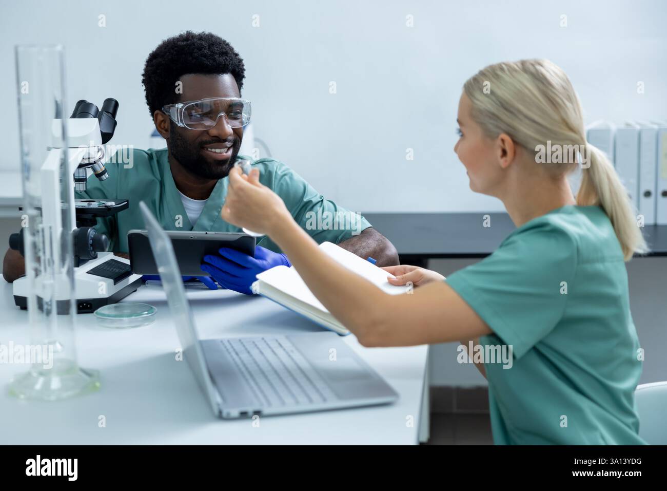 Colleagues scientists diligently working in modern laboratory using ...