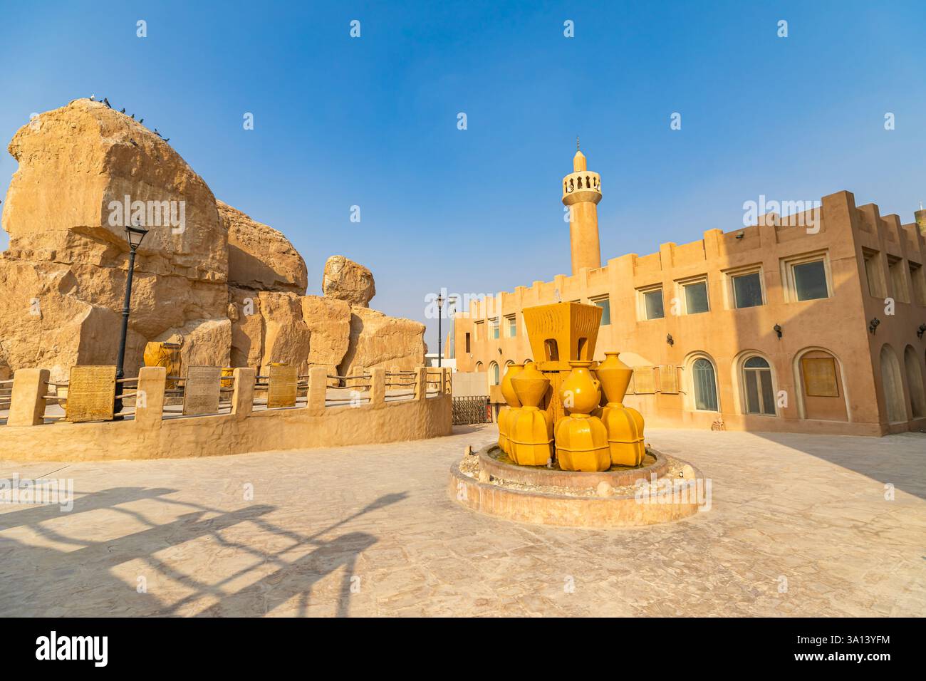 Traditional architecture with minaret and yellow fountain near Jabal Al ...
