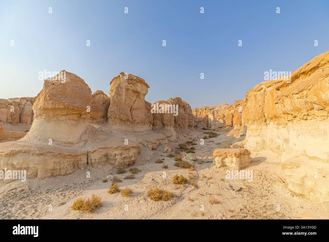 Wind-sculpted sandstone formations rise from the desert floor in Jabal ...