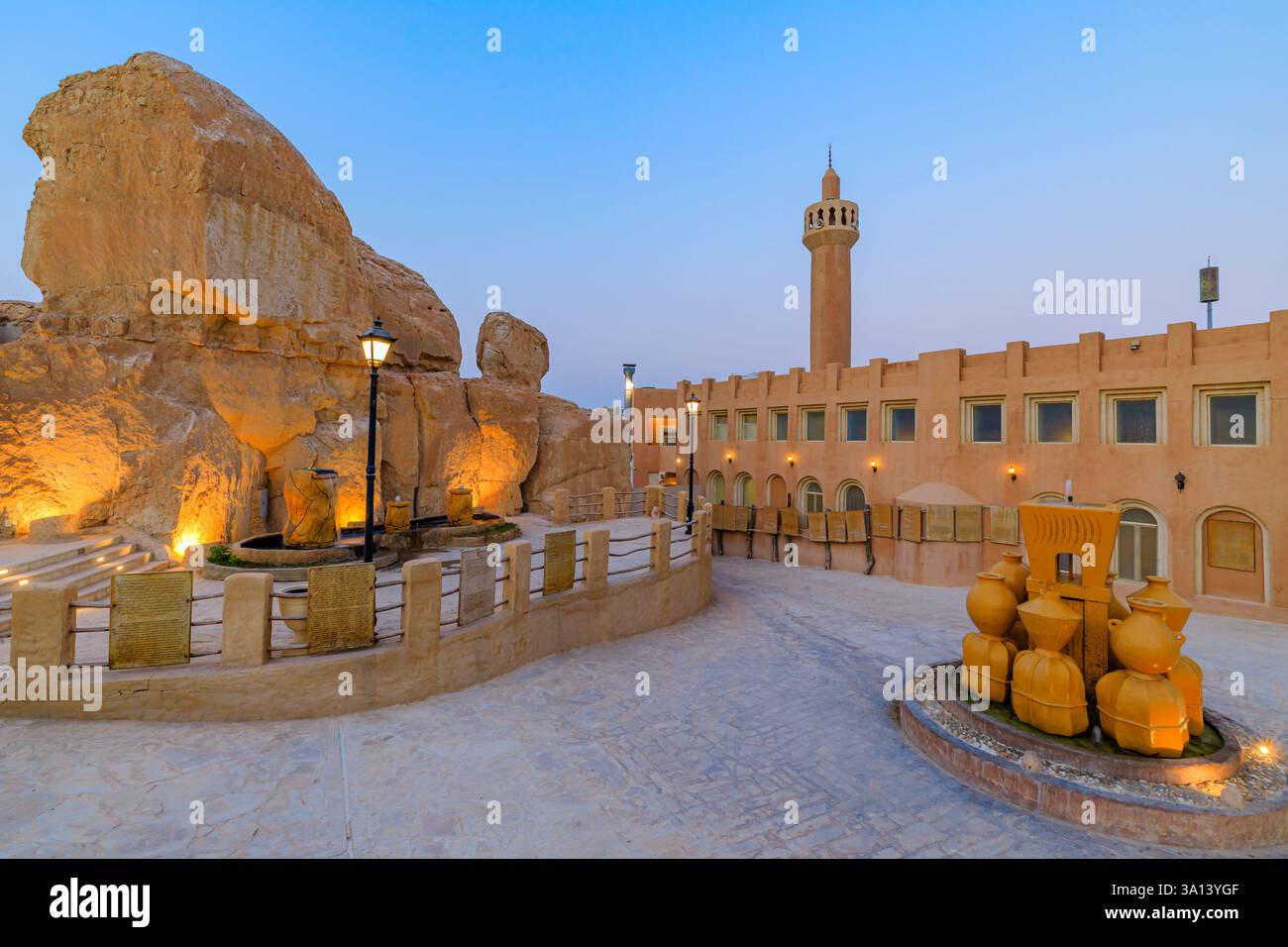 Illuminated rock caves and mosque of Jabal Al Qarah mountain with ...