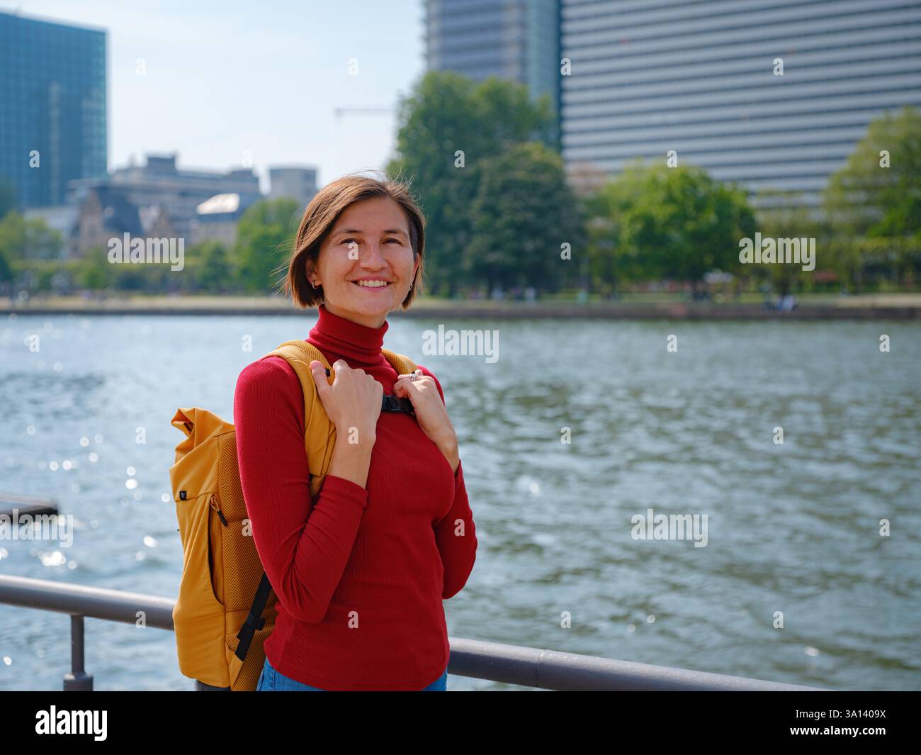 Tourist woman explores modern Frankfurt, walking through vibrant ...