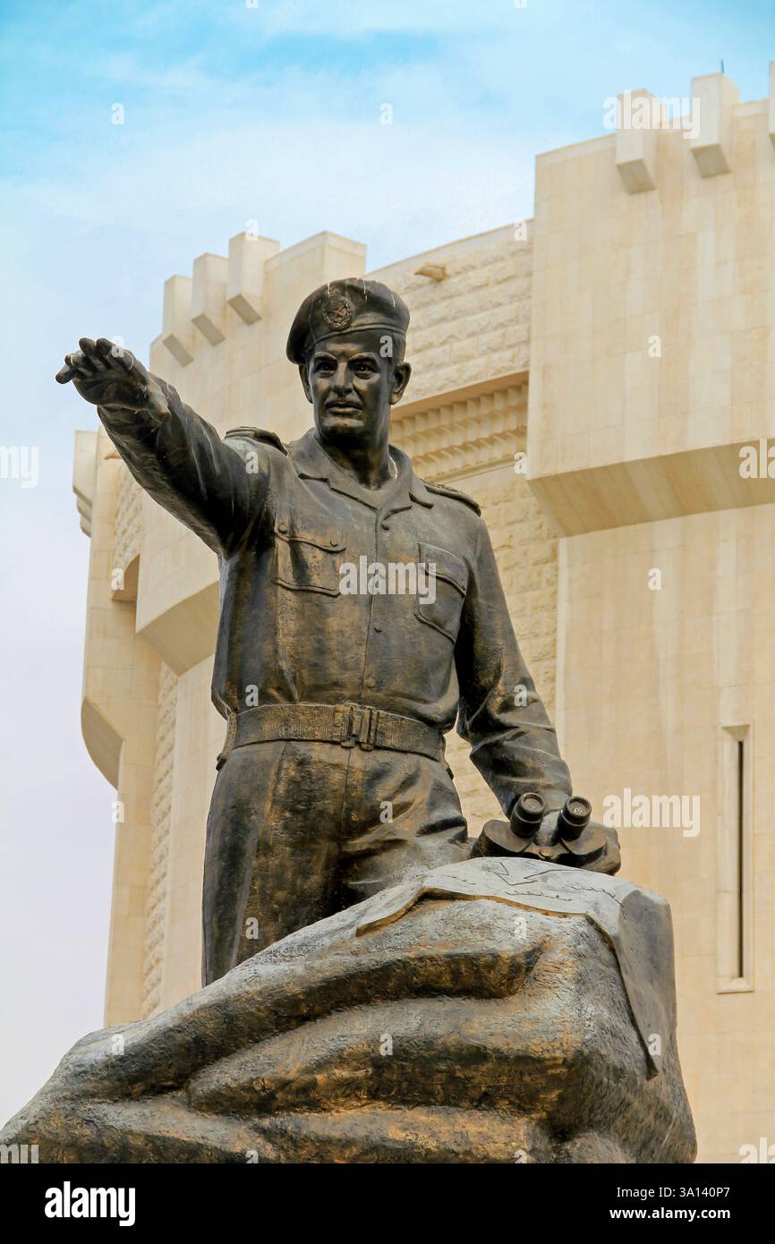 A bronze statue of a military figure with an outstretched arm stands ...