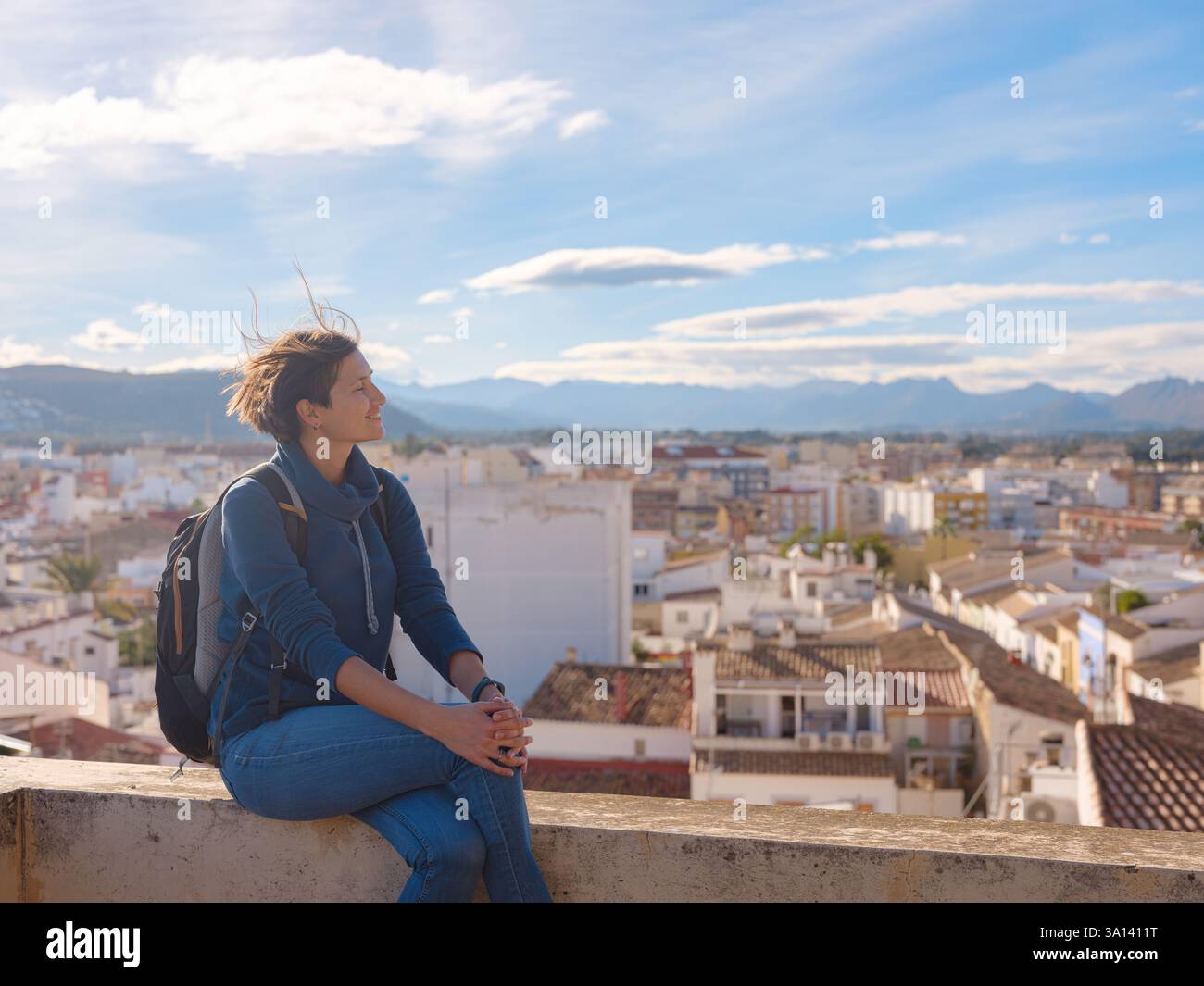 Young woman exploring historic castle in Denia, Alicante province ...