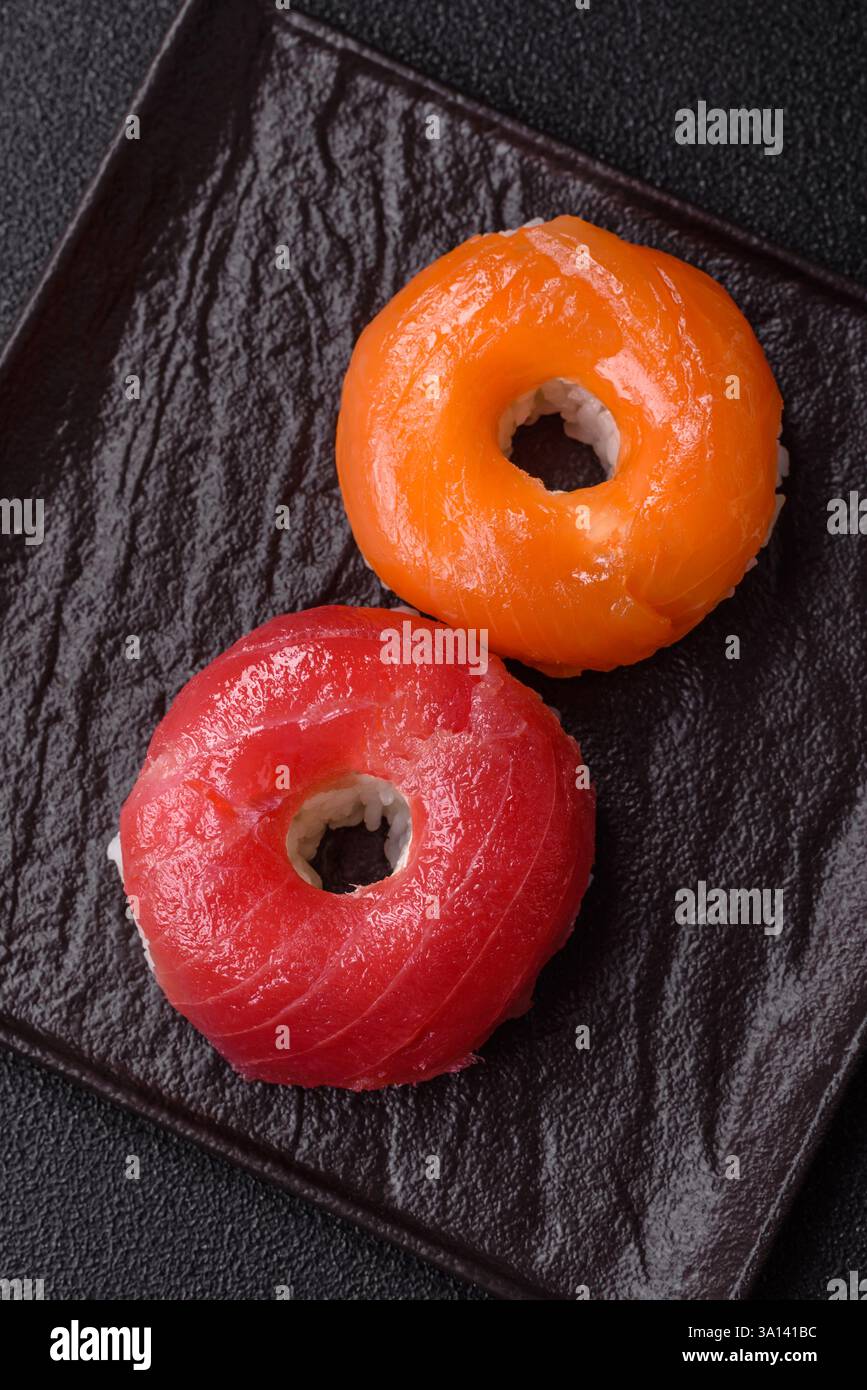 Donut shaped sushi rolls with salmon, shrimp and tuna, salt, spices and ...