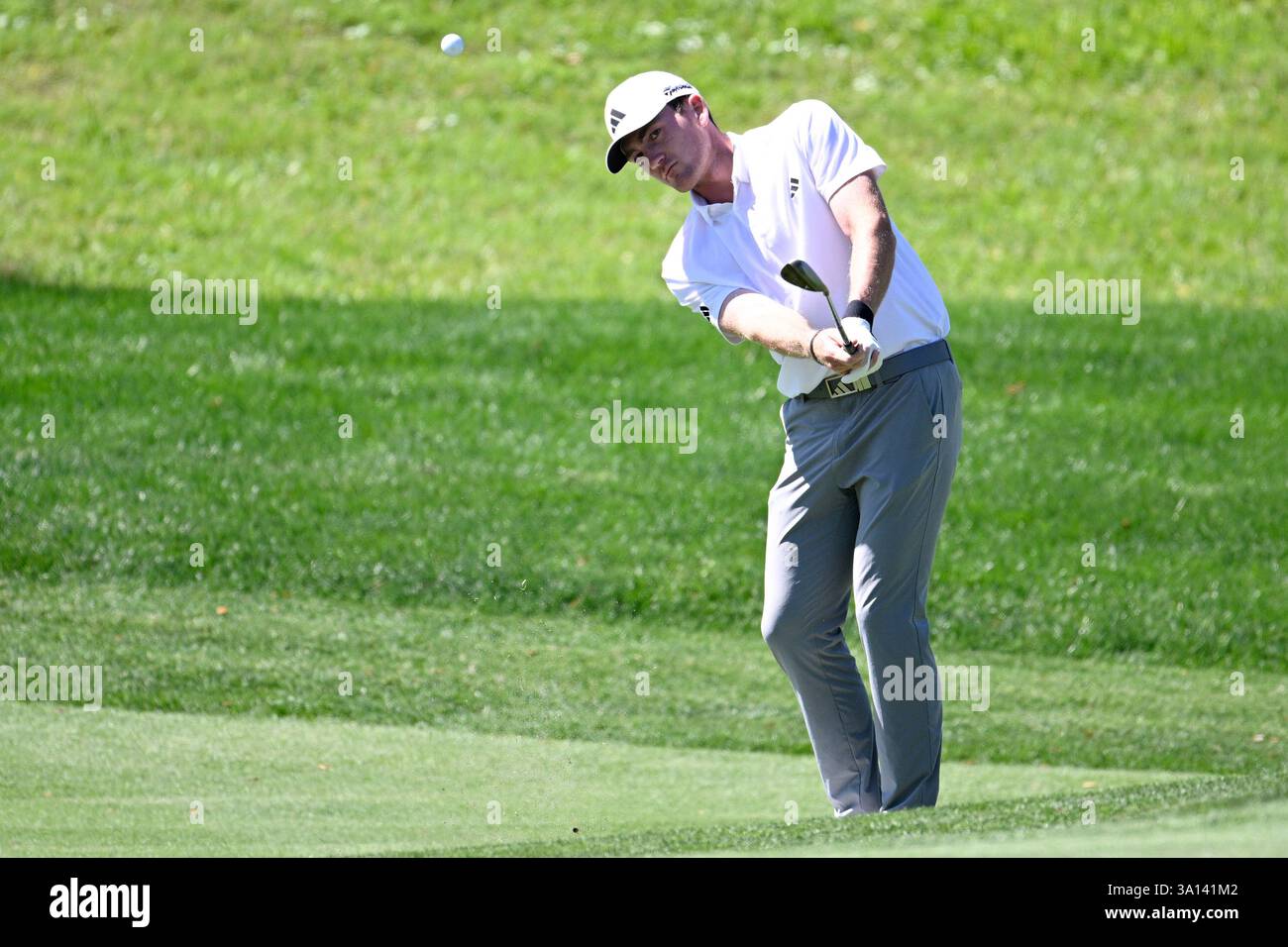 Nick Dunlap chips to the second green during the first round of the ...