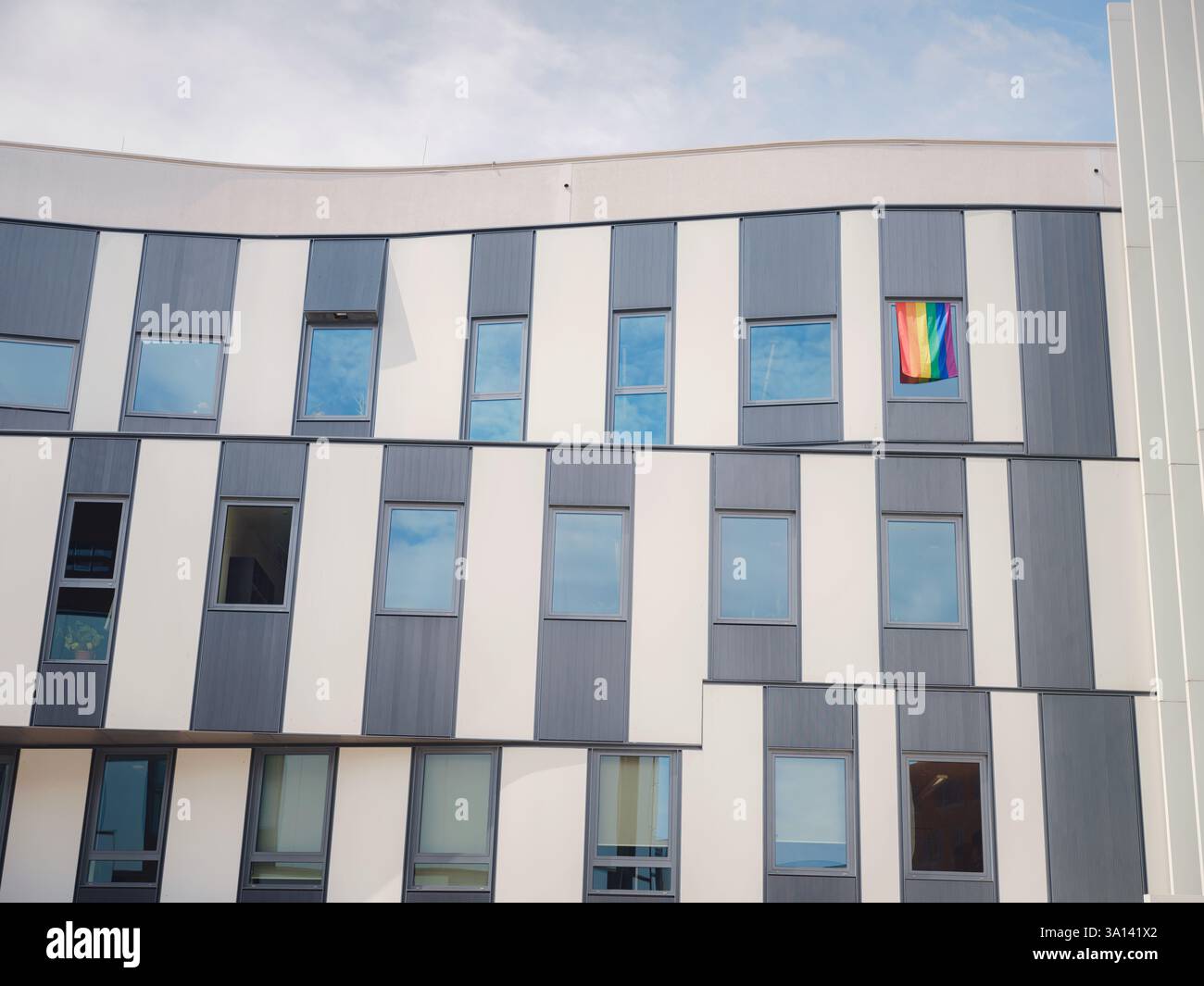 Facade of modern building with sleek design, displaying LGBTQ pride ...