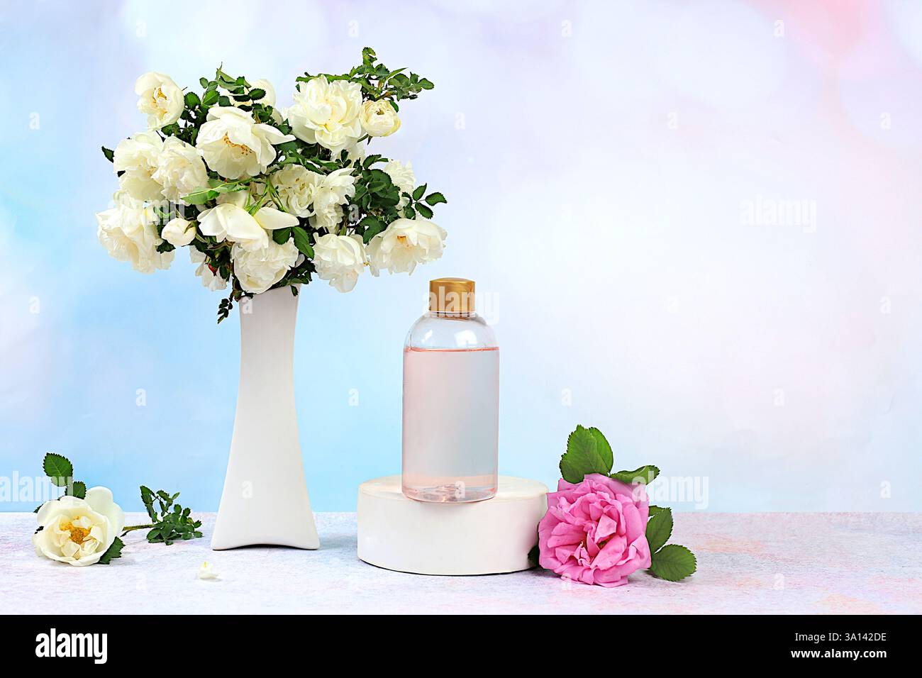 Spa and wellness composition with rose water and fresh rose flowers ...