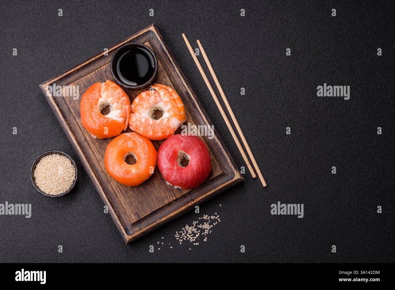 Donut shaped sushi rolls with salmon, shrimp and tuna, salt, spices and ...